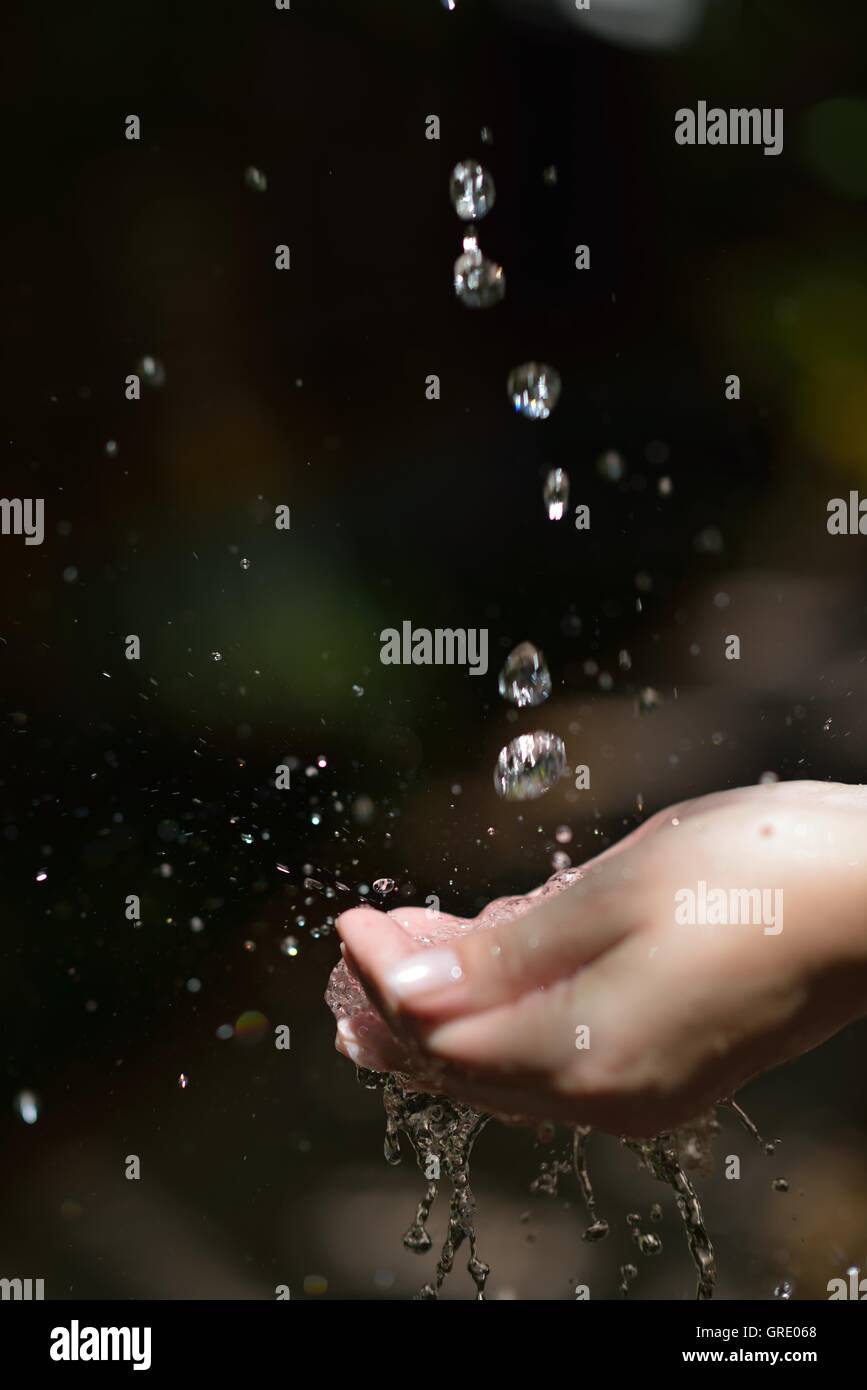 water stream on woman hand Stock Photo - Alamy
