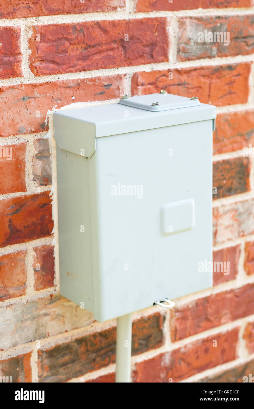 Electric control box on red brick wall Stock Photo - Alamy