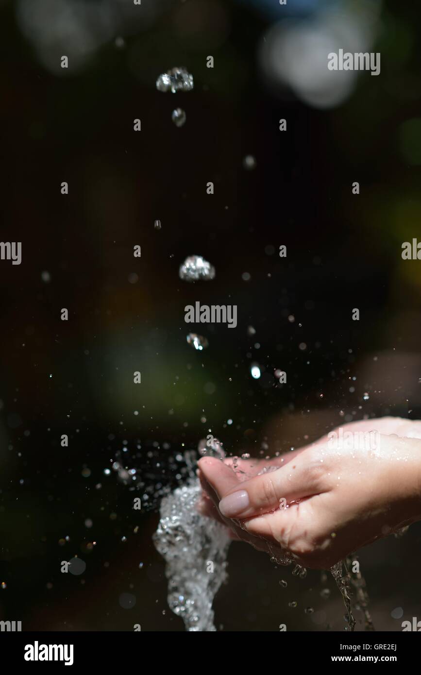 water stream on woman hand Stock Photo - Alamy