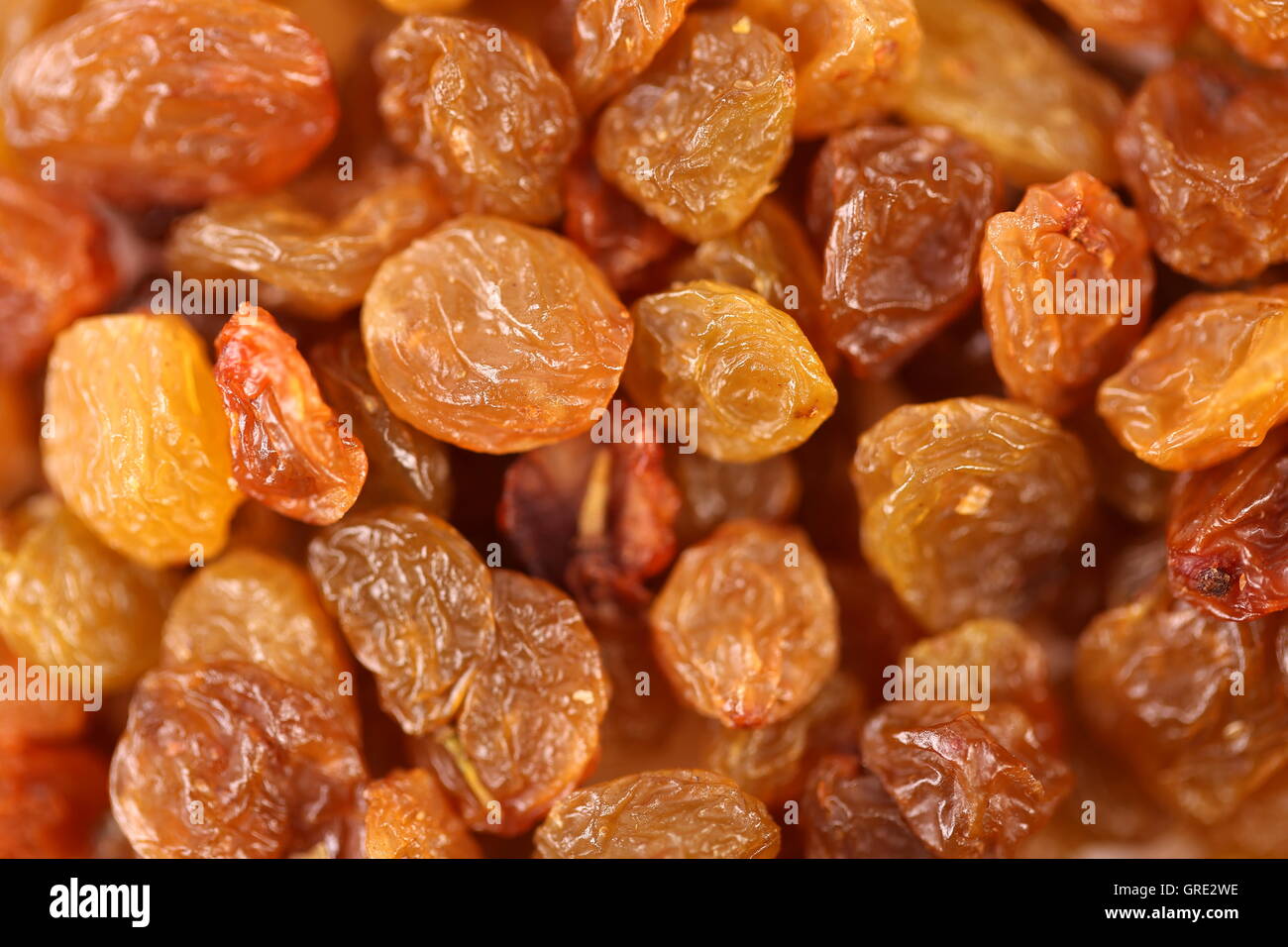 Golden raisins background Stock Photo - Alamy