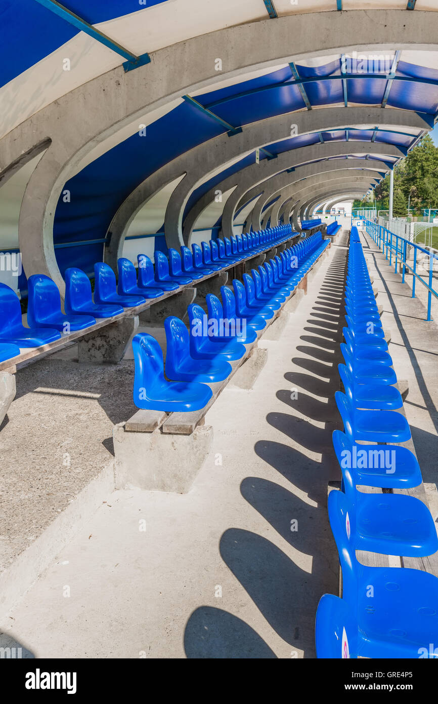 Seats on tribune sports stadium in the park near medieval castle in ...