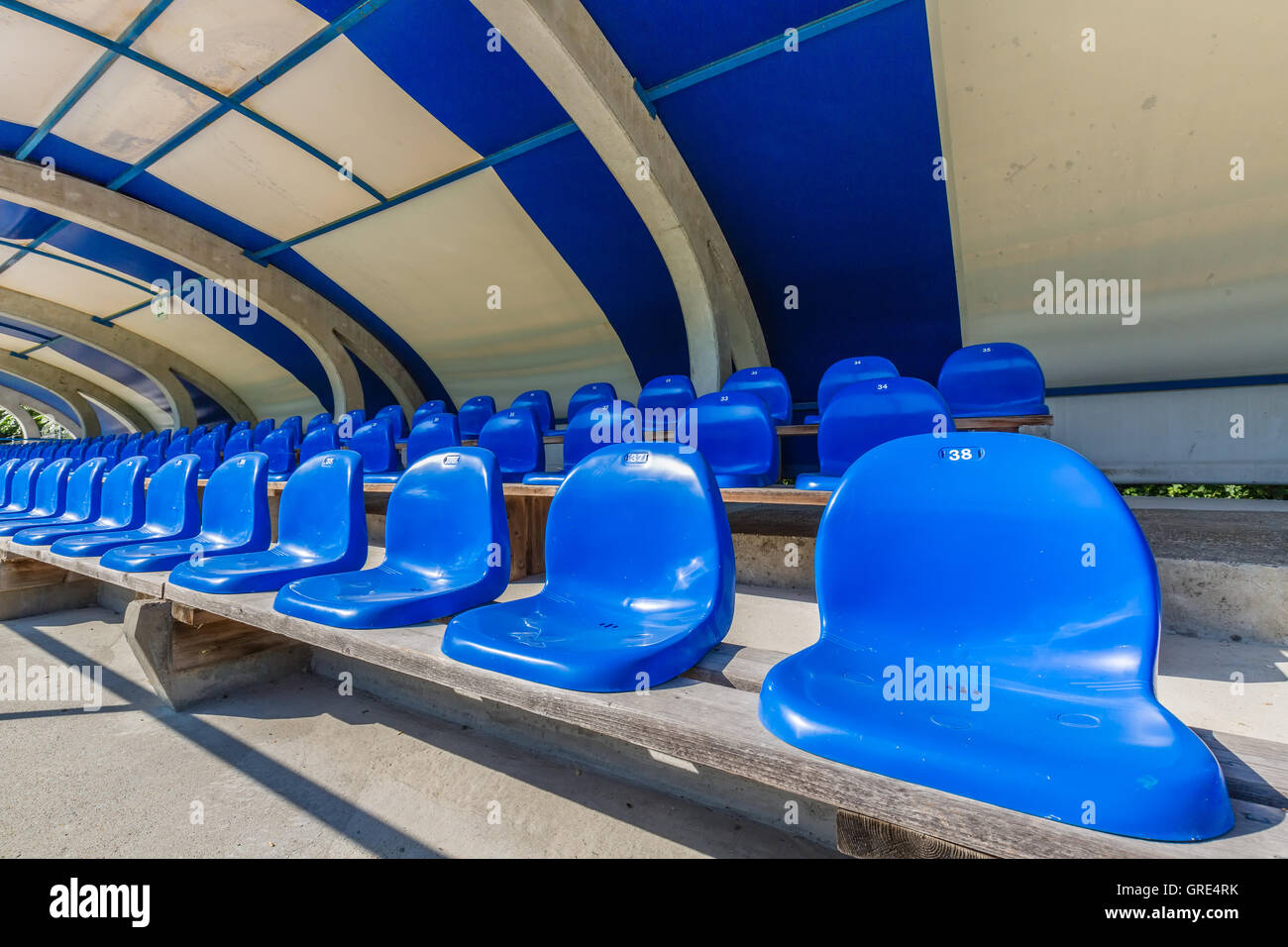 Seats on tribune sports stadium in the park near medieval castle in ...