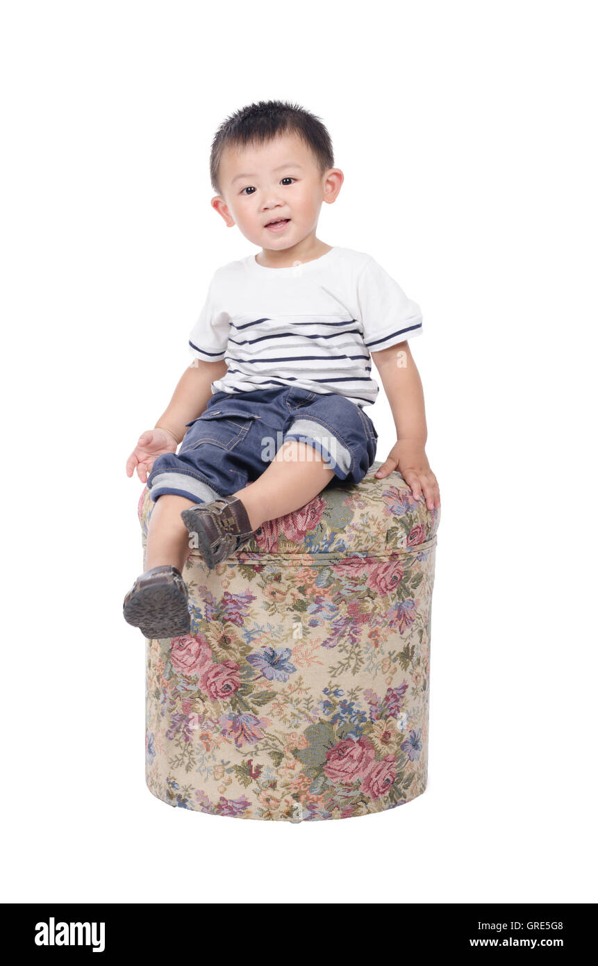 Boy sitting on chair Stock Photo - Alamy