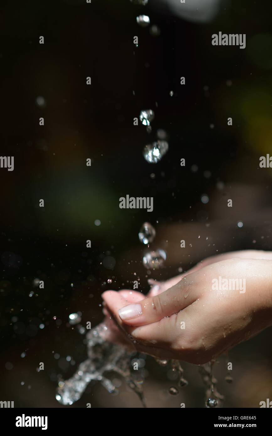 water stream on woman hand Stock Photo - Alamy