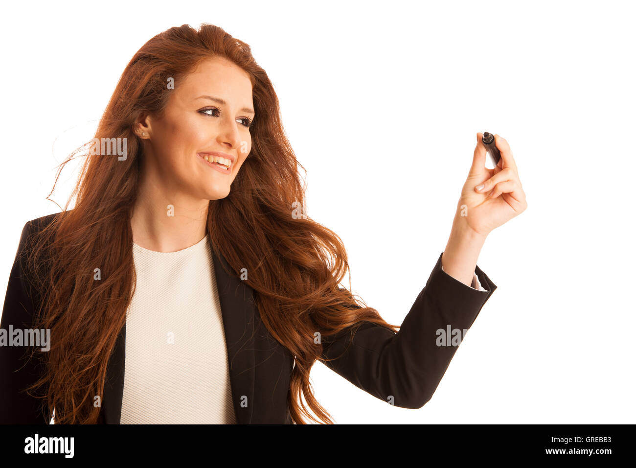 Young businesswoman writing on transparent board against white ...
