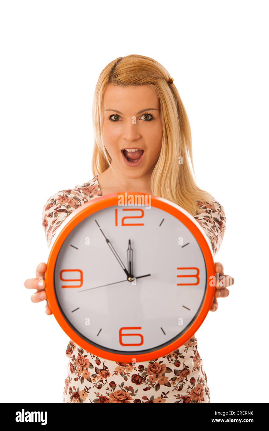 Cute blond woman with a big orange clock gesturing being late isolated ...
