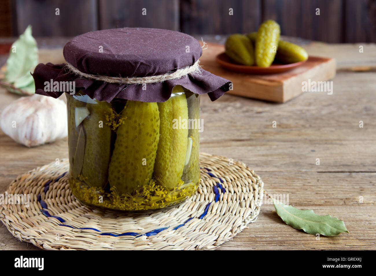 Homemade pickles in jar over rustic wooden background with copy space ...