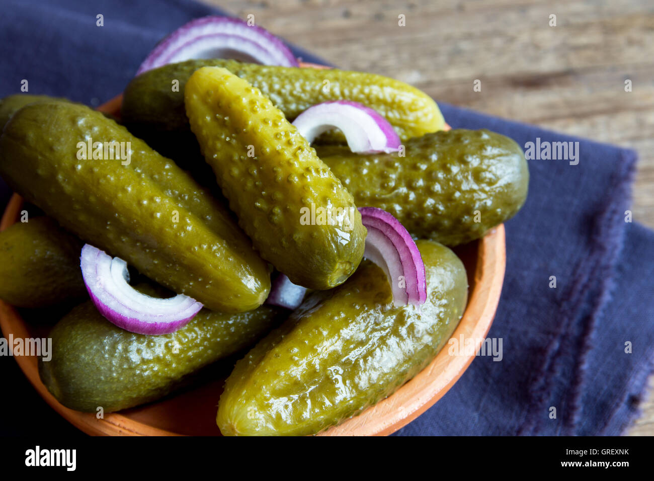 Homemade pickles with red onion over rustic wooden background Stock ...