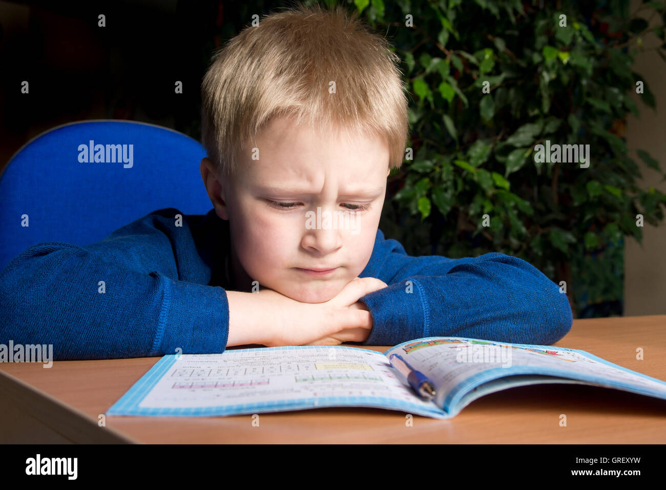 Tired boring boy don't want to do his difficult school homework Stock ...
