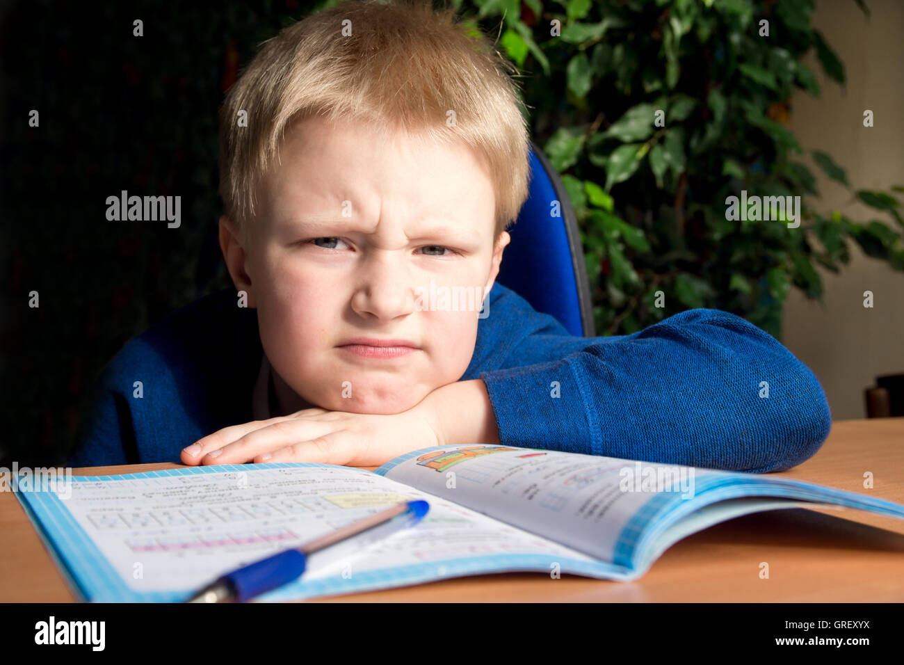 Tired boring boy don't want to do his difficult school homework Stock ...