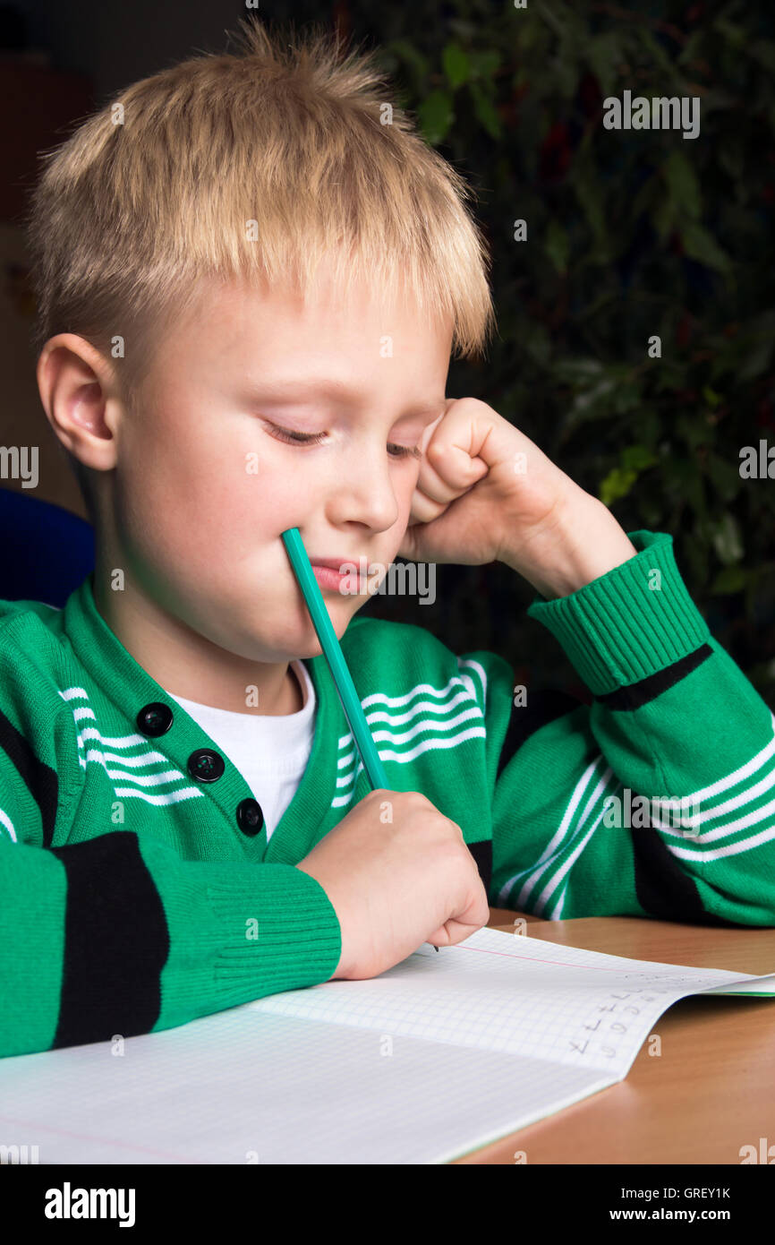 Schoolboy doing his difficult school homework with problems Stock Photo ...