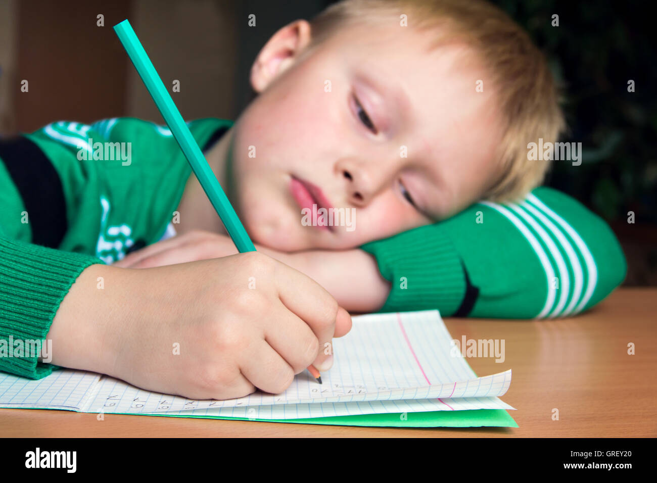 Tired boring boy doing his difficult school homework Stock Photo - Alamy