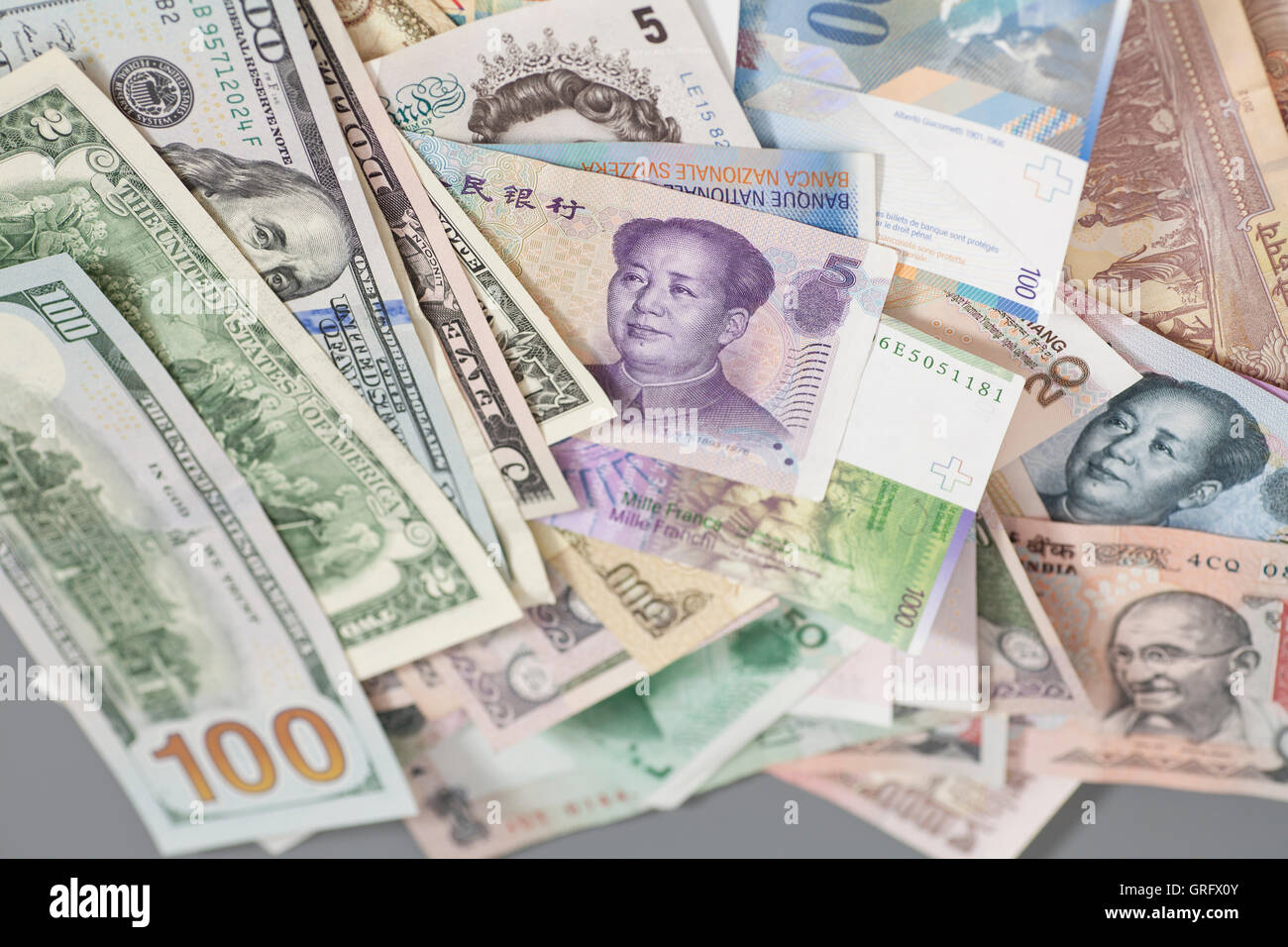 International currencies isolated on gray backgrond Stock Photo - Alamy