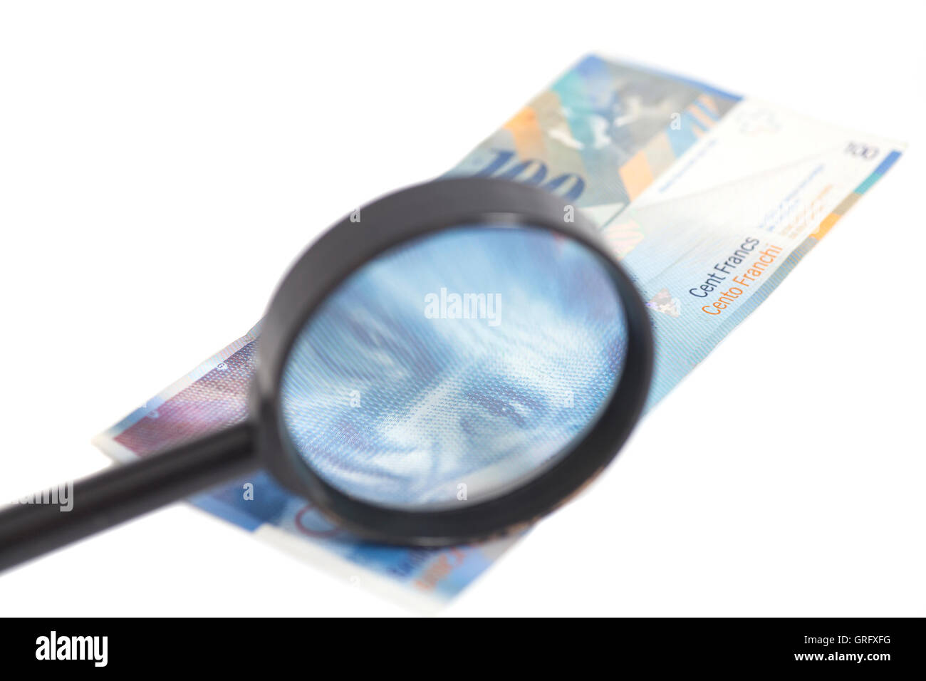 Swiss 100 Franc banknotes under magnifying glass isolated on white ...