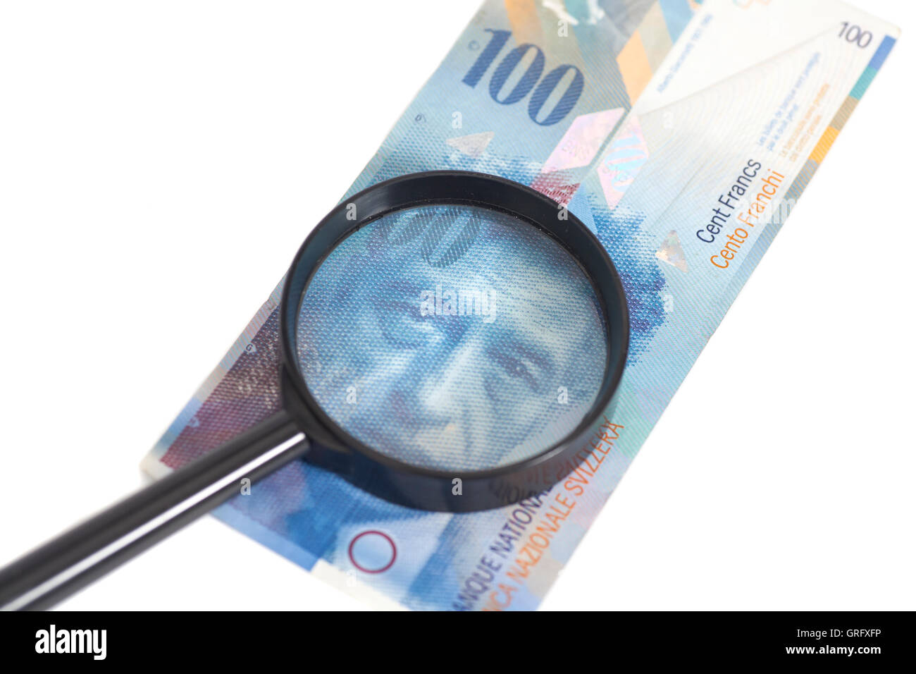 Swiss 100 Franc banknotes under magnifying glass isolated on white ...