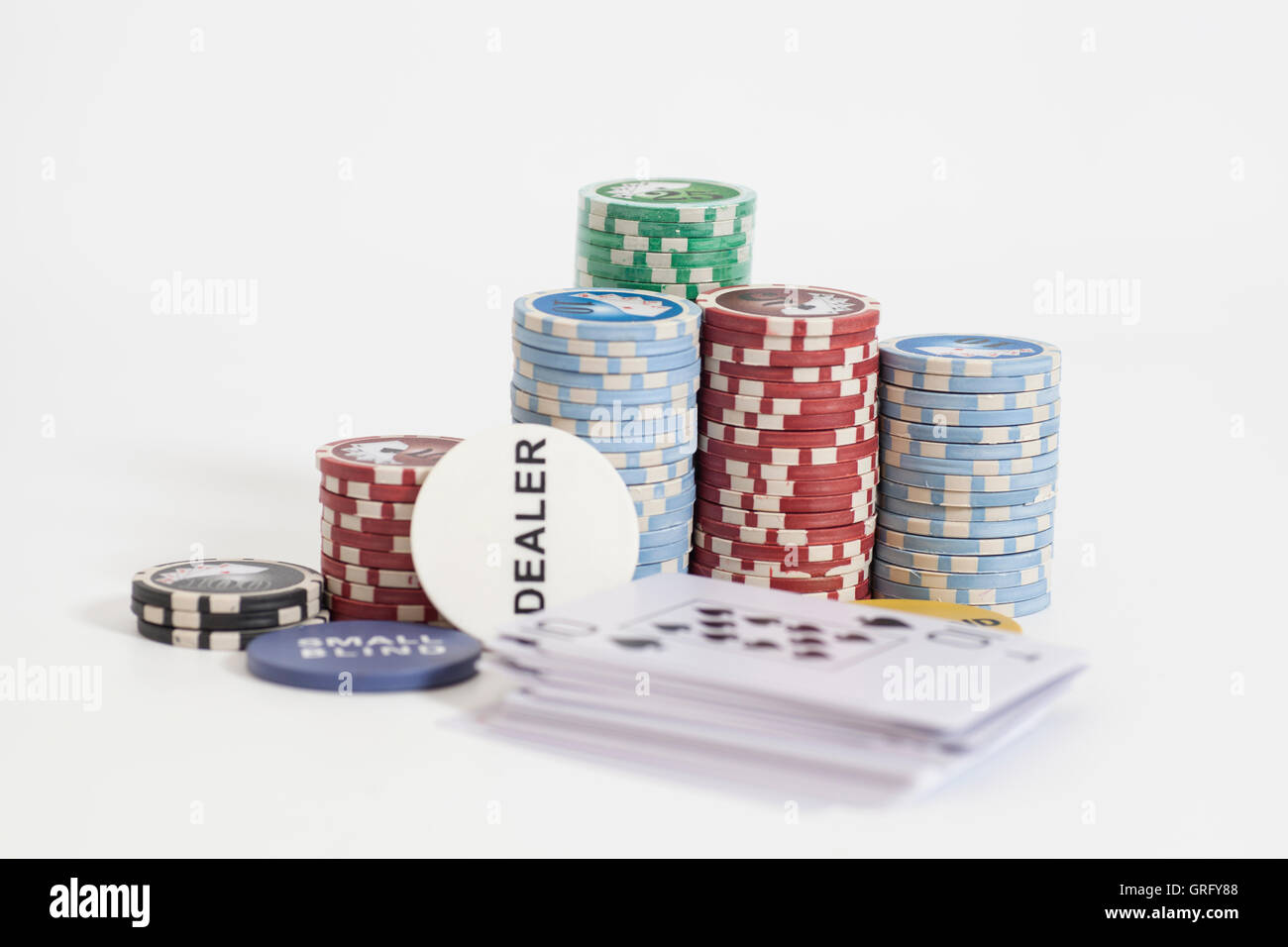 Poker dealer chips,playing card and poker chips stack on white ...