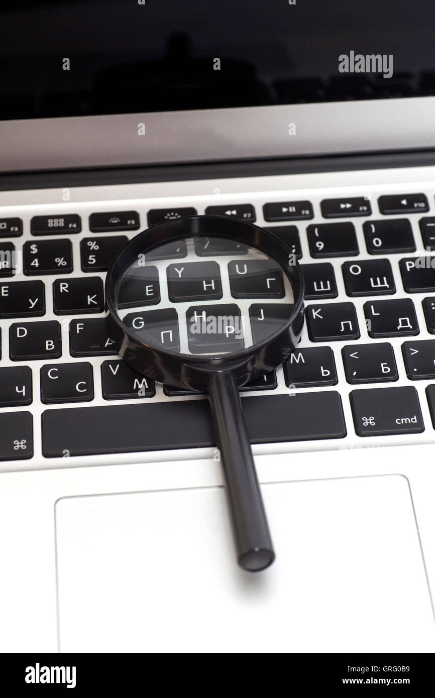 Laptop With Magnifying Glass Stock Photo - Alamy
