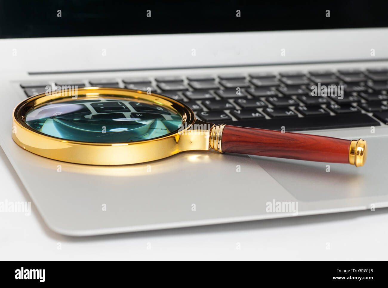 Laptop With Magnifying Glass on white Stock Photo - Alamy