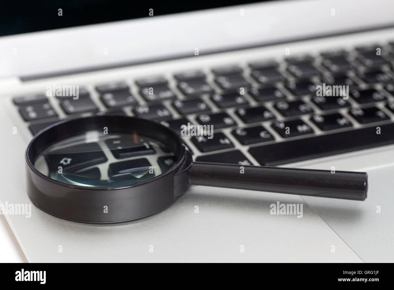 Laptop With Magnifying Glass.Close up Stock Photo - Alamy
