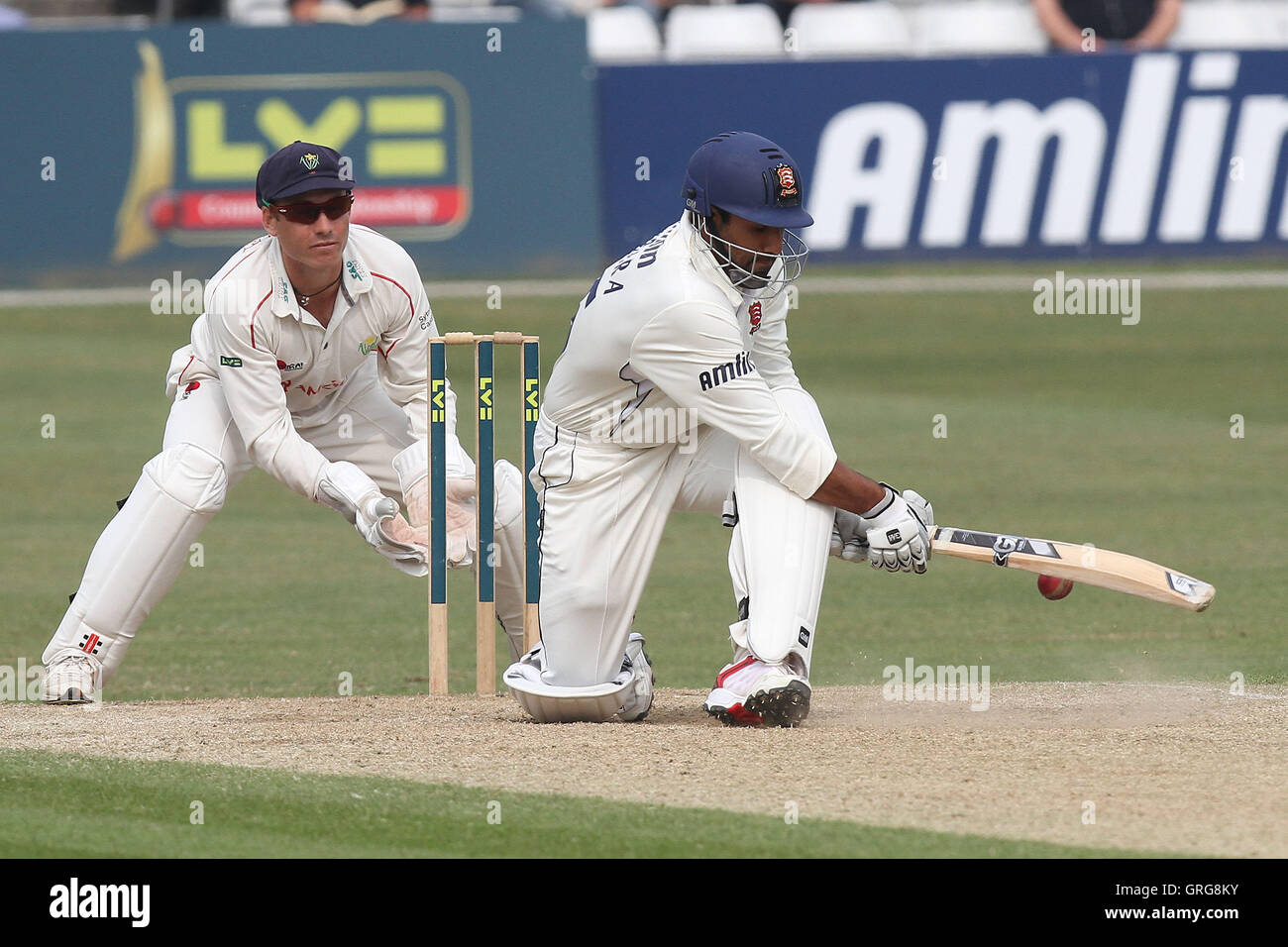 Ravi Bopara of Essex plays the sweep shot as Mark Wallace looks on ...