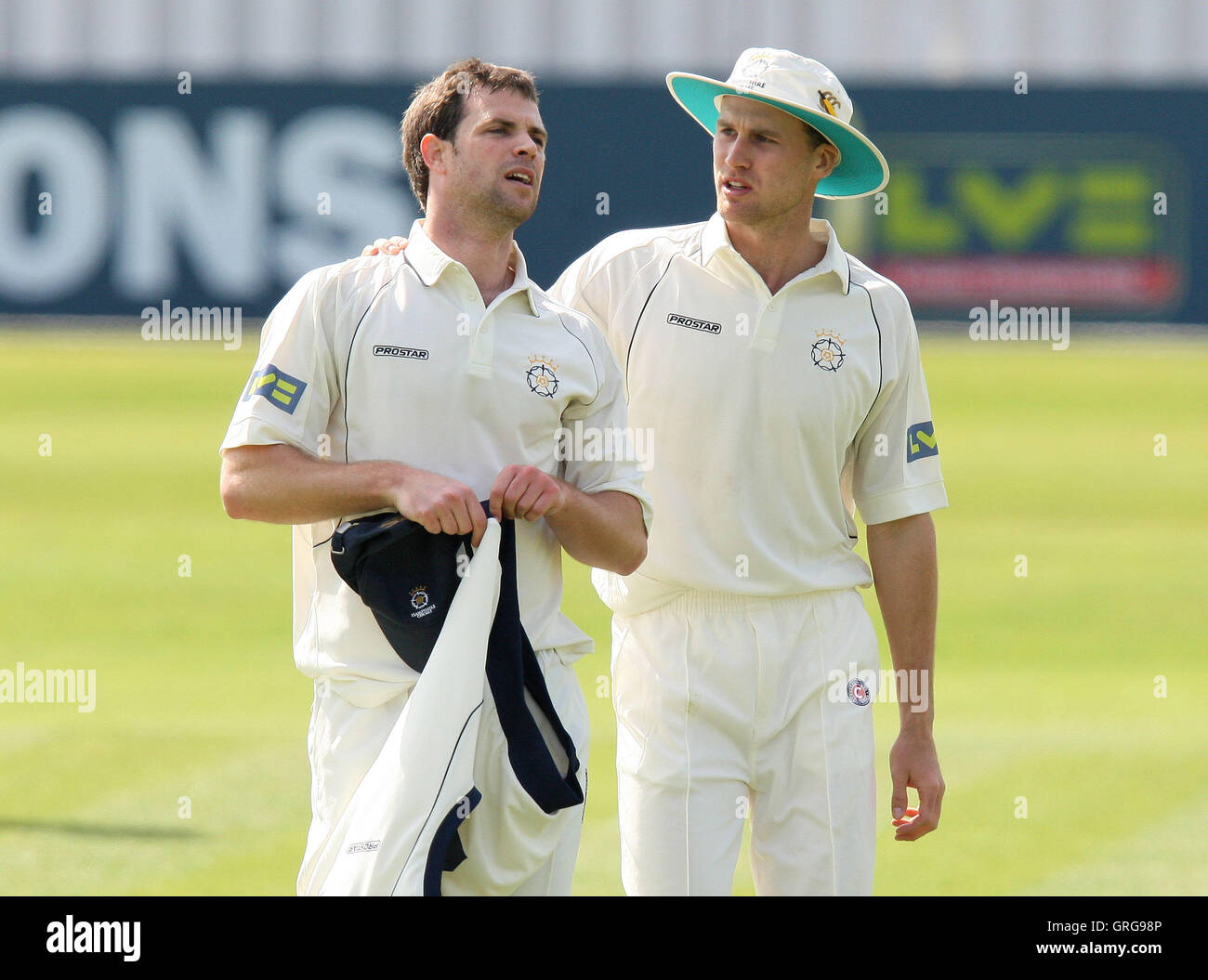 James Tomlinson of Hants (L) talks tactics with Chris Benham - Essex ...