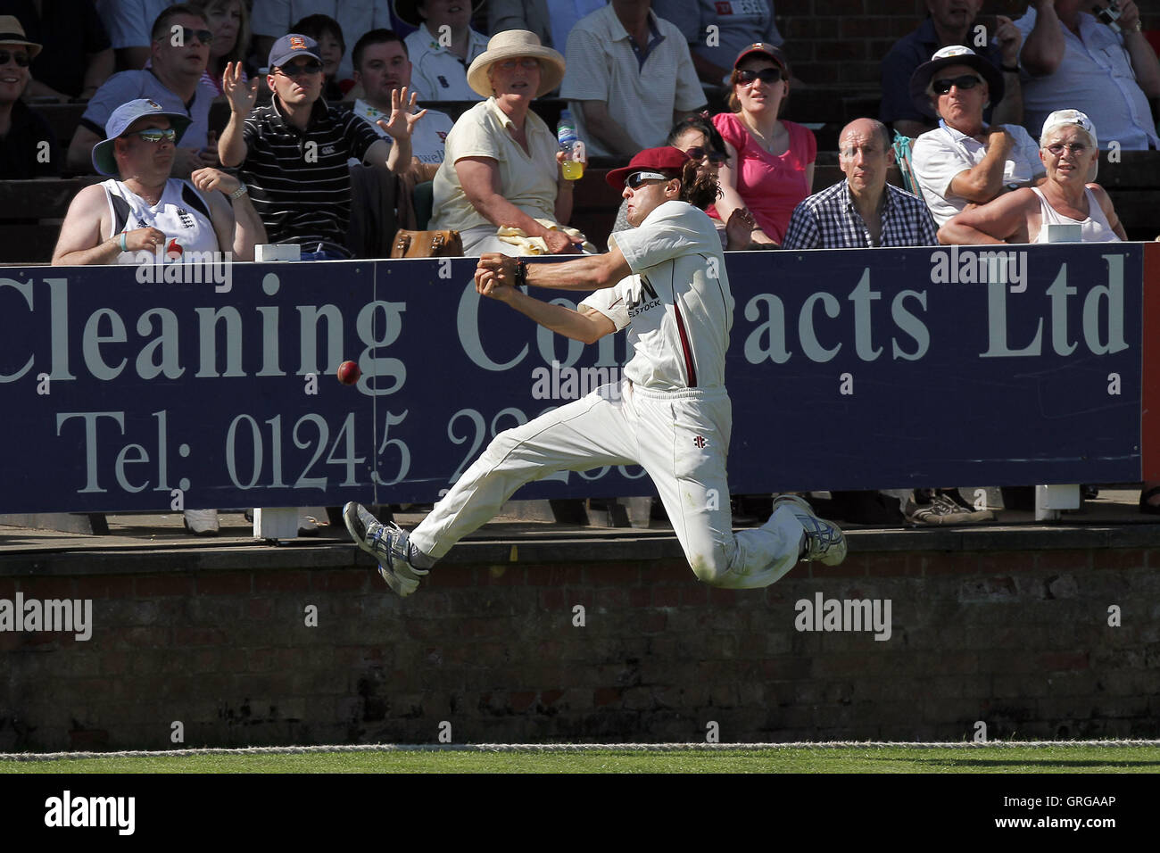 Jack Brooks of Northants just fails to make a catch on the boundary and ...