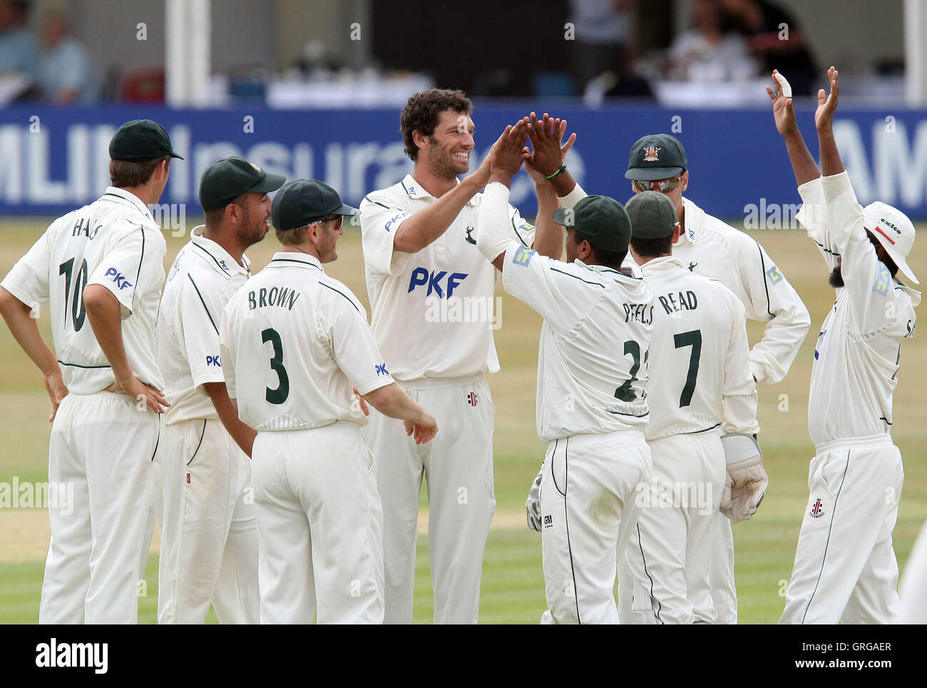 Charlie Shreck of Notts (4th L) celebrates the wicket of Billy Godleman ...