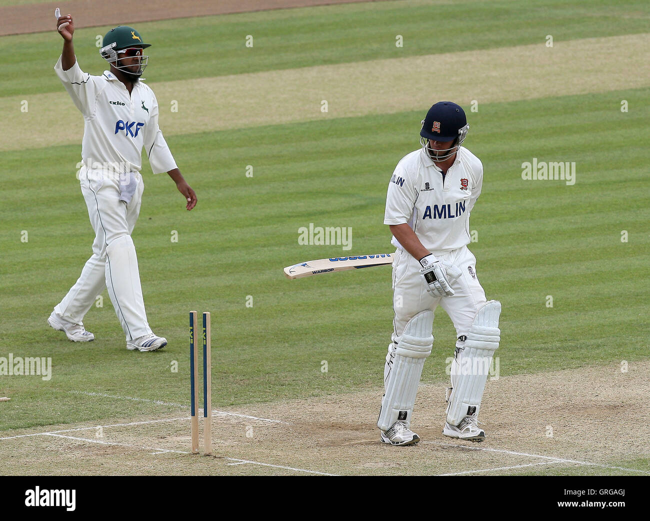 Mark Pettini of Essex is bowled out by Andre Adams as Bilal Shafayat ...