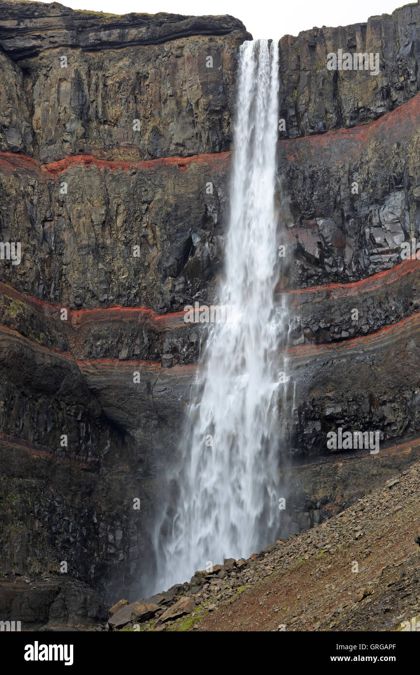 Hengifoss waterfall showing the red deposits in the cliff Stock Photo ...