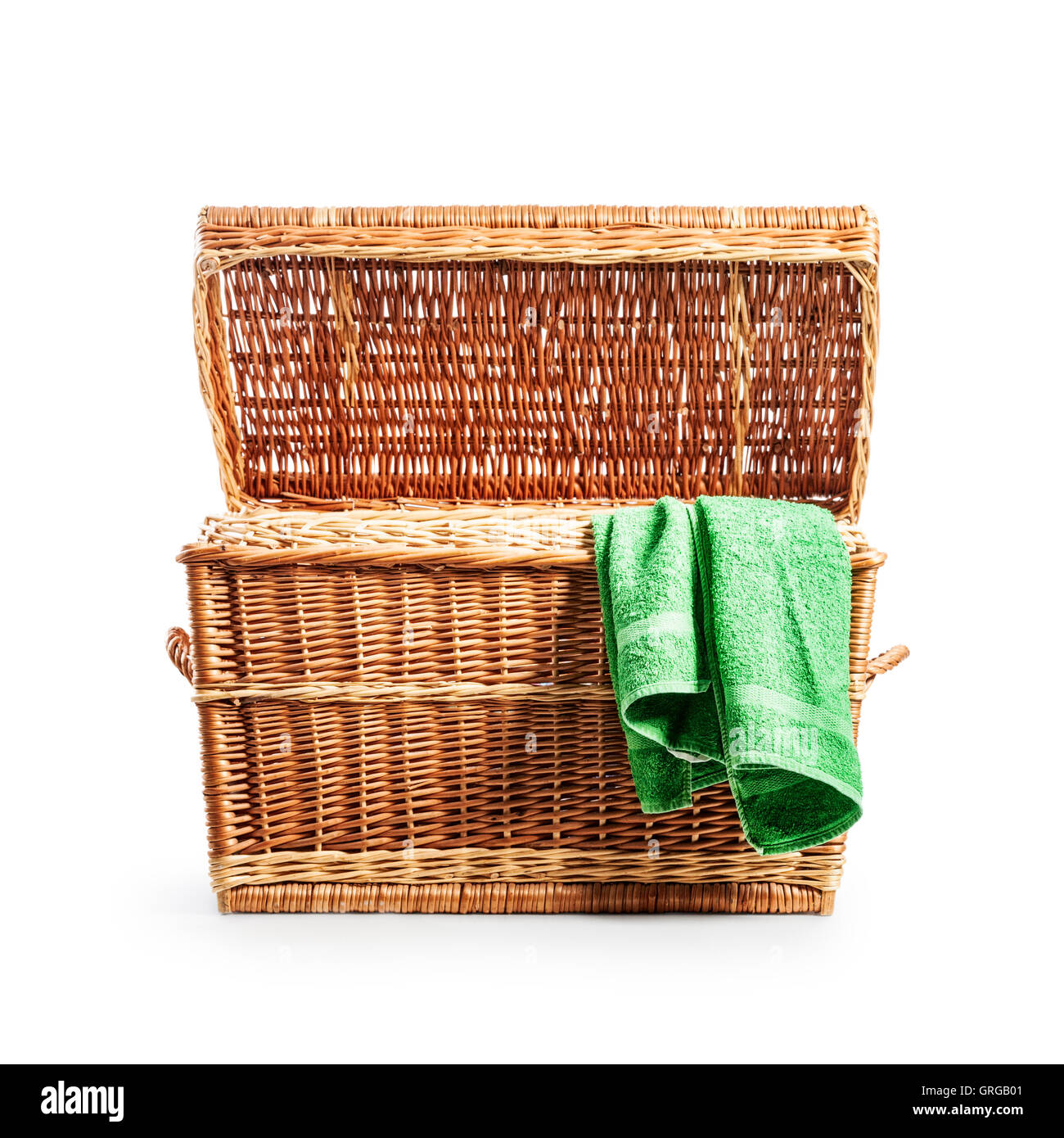 Open wicker clothes box. Laundry basket with green towel. Treasure ...