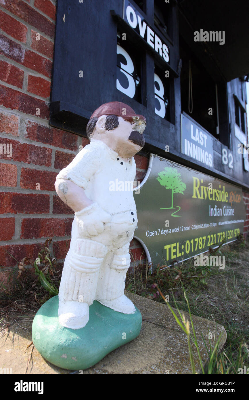 A gnome looks on from a position near the scoreboard at Coggeshall CC ...
