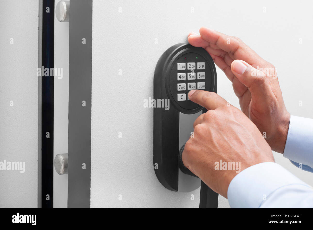 Interracial businessman hand entering security system code Stock Photo ...