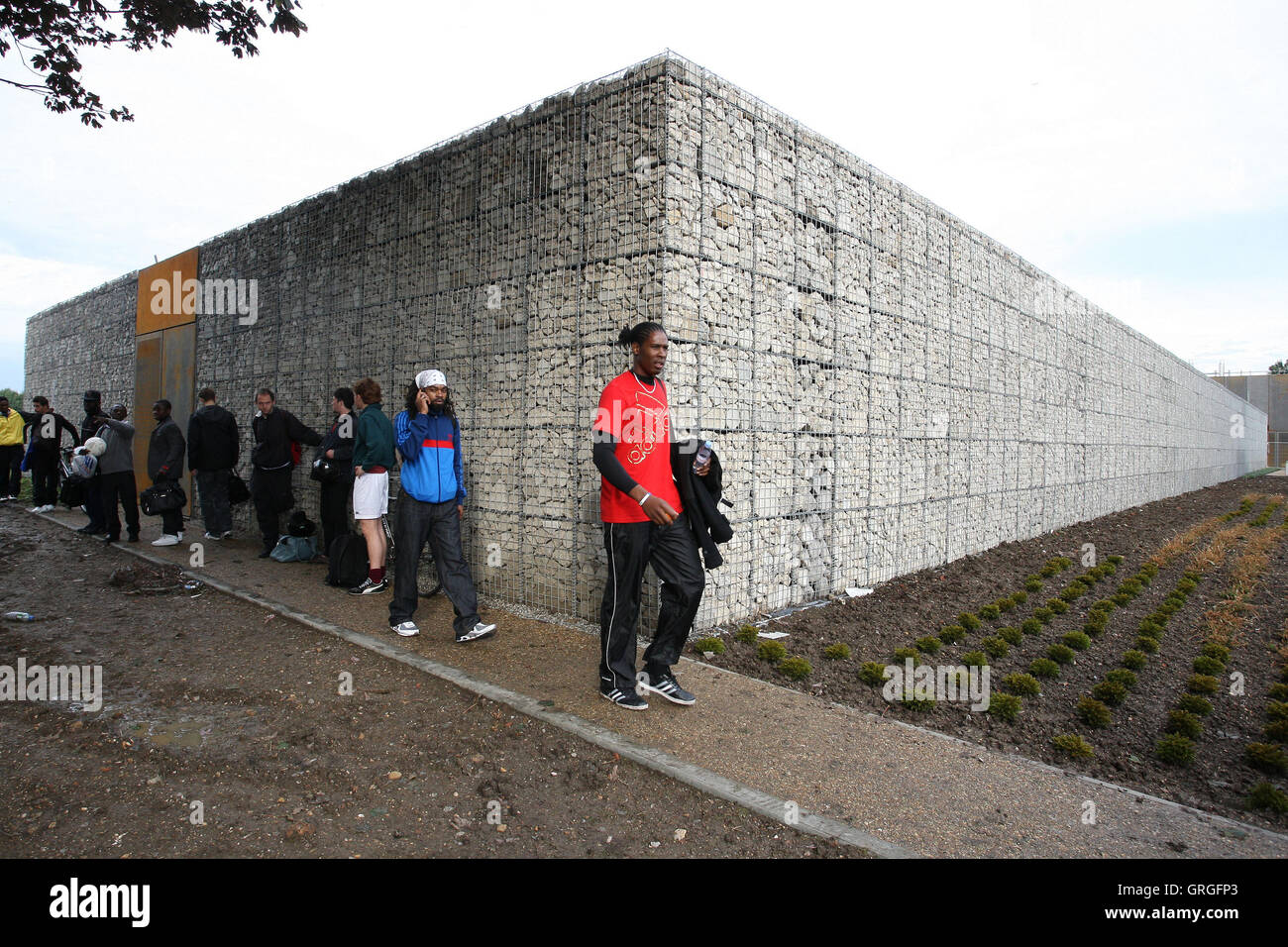Players walk past the construction work for the new dressing room block ...