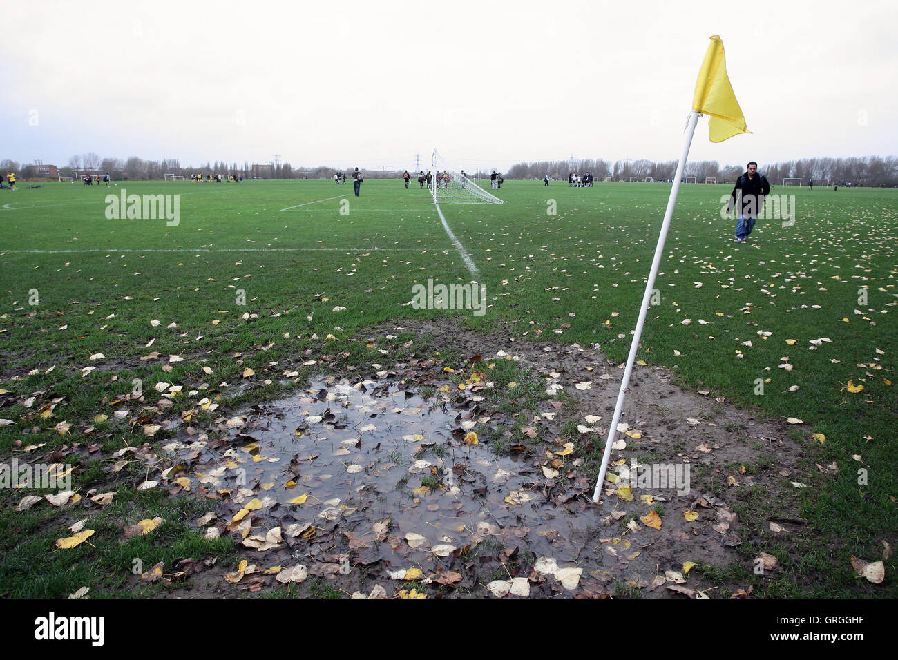 A corner flag is seen in a large puddle after heavy rain on football ...