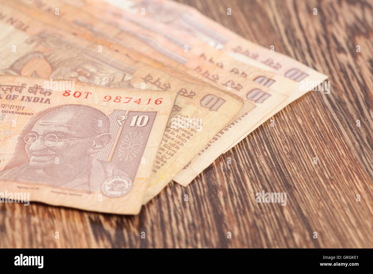 Ten rupee notes (Indian Currency) on wooden background Stock Photo - Alamy
