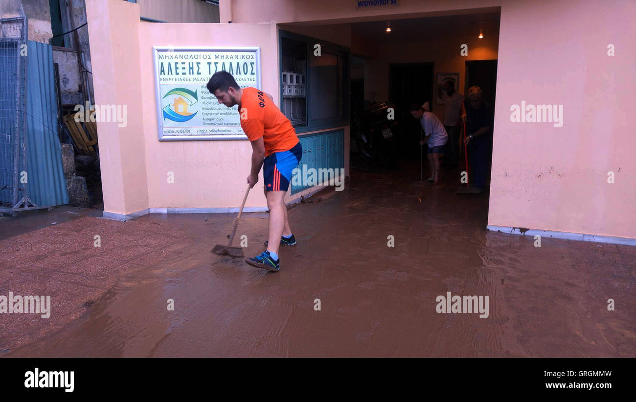 Athens, Greece. 7th Sep, 2016. People clean mud brought by flood on the ...