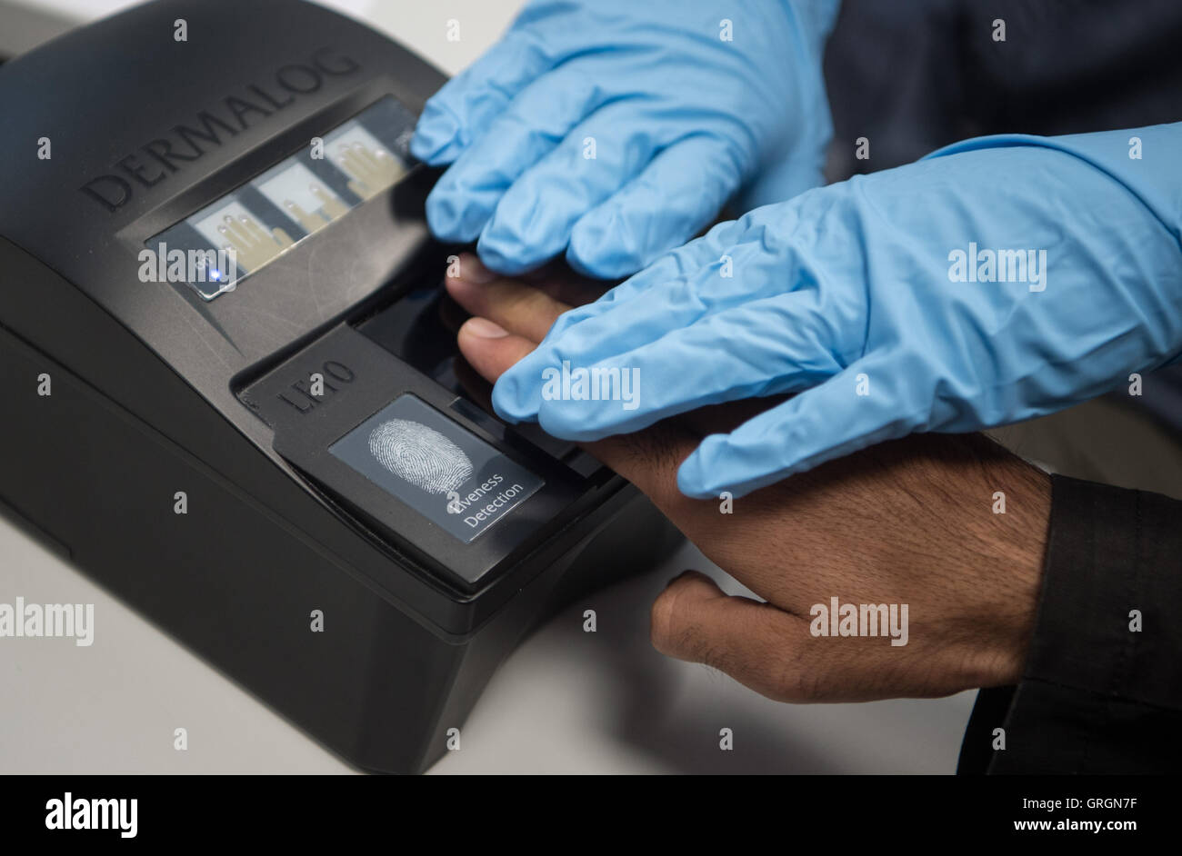 Giessen, Germany. 7th Sep, 2016. An asylum-seeker has his fingerprints ...