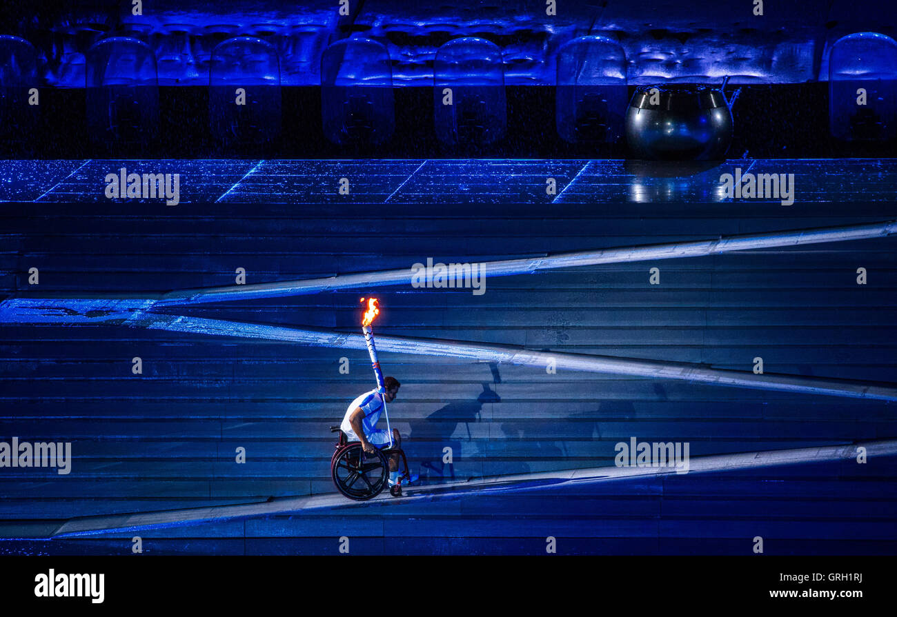Clodoaldo Silva climbs a ramp to light the cauldron during the Opening ...