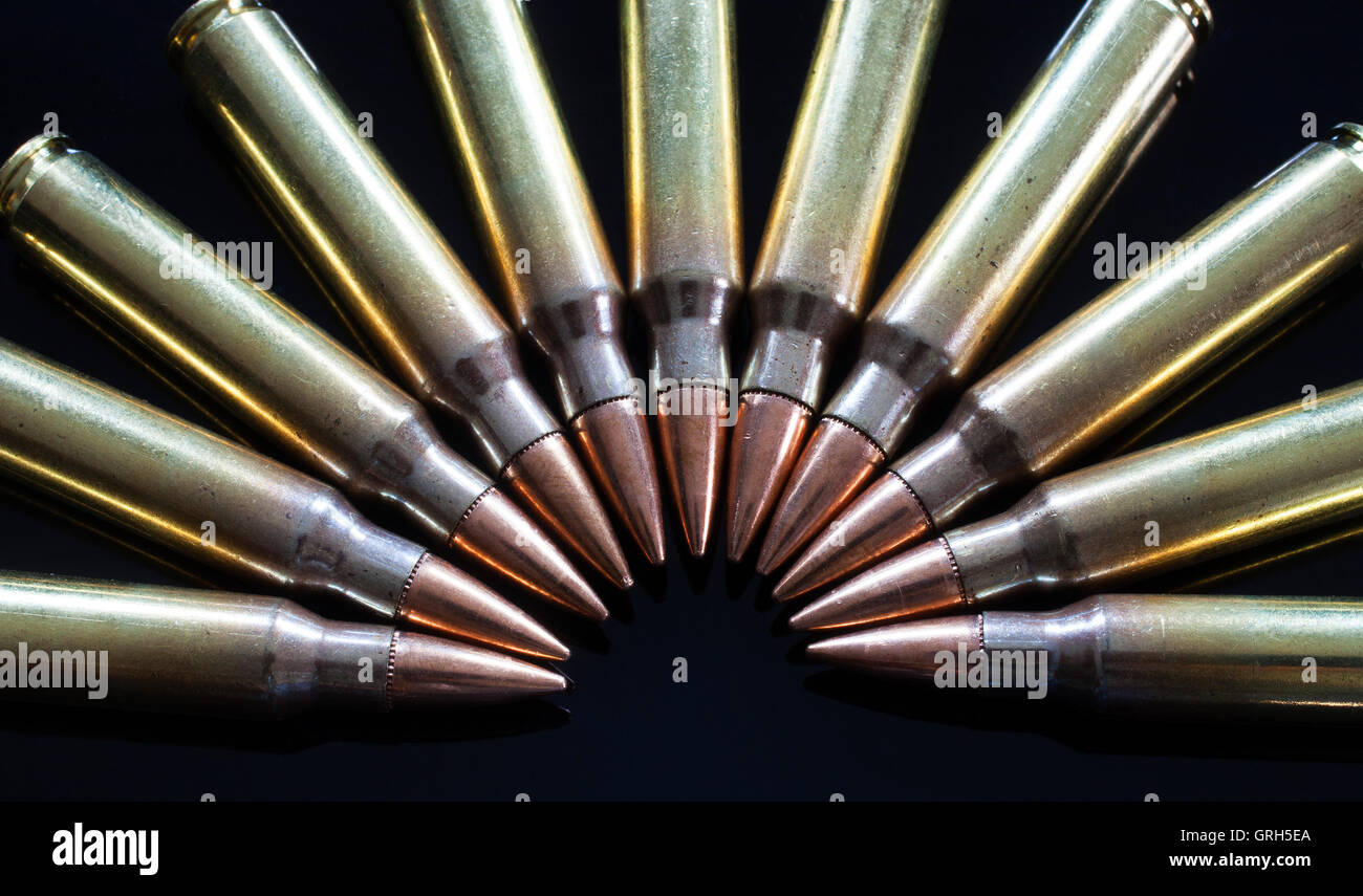 Rifle cartridges with bullets that have steel inside on a black ...