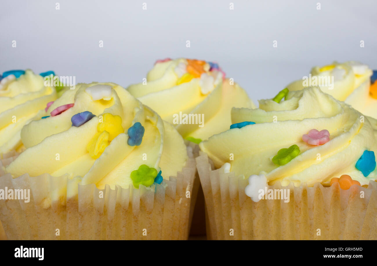 Yellow frosted cupcakes up close with a white background Stock Photo ...