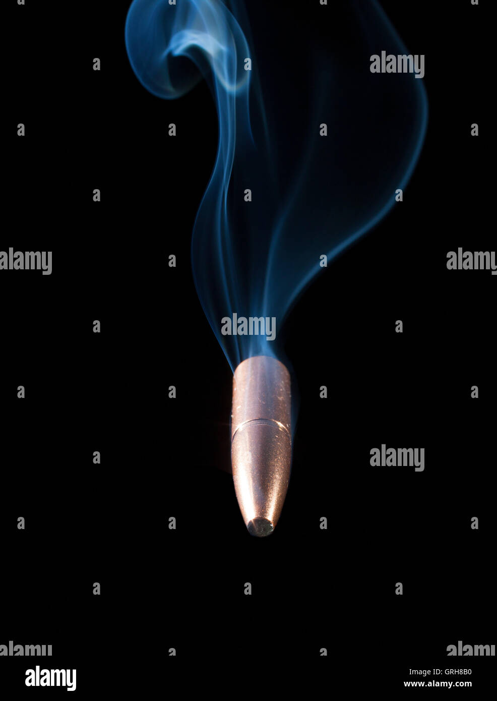 Copper colored bullet with smoke behind heading toward the viewer Stock ...