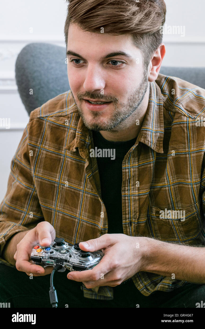Man playing a play station hi-res stock photography and images - Alamy
