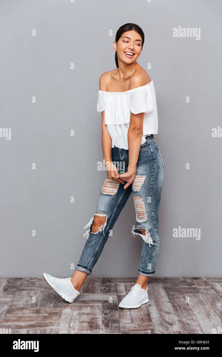 Full length portrait of a casual beautiful woman posing isolated on a ...