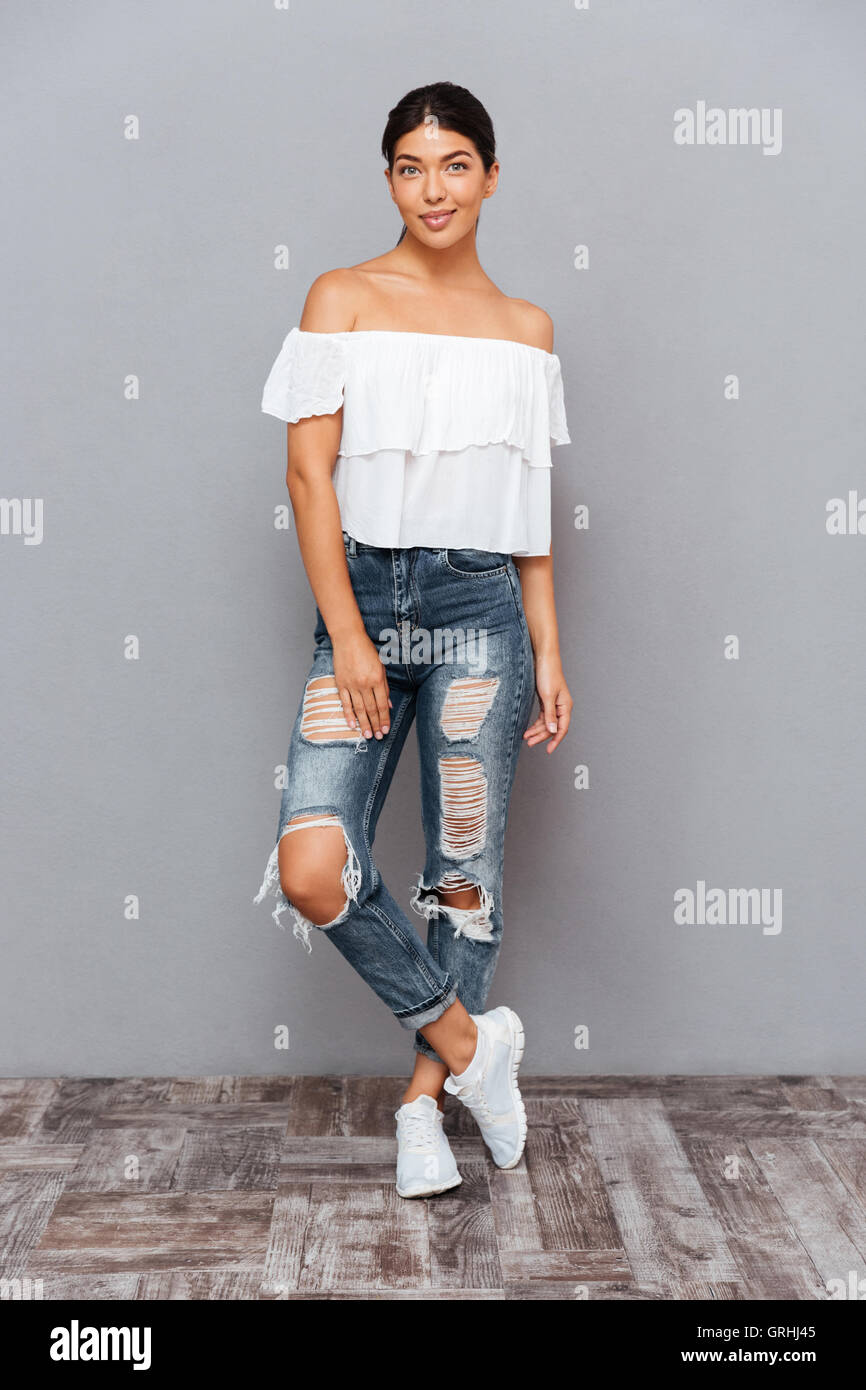 Full length portrait of a casual beautiful woman posing isolated on a ...