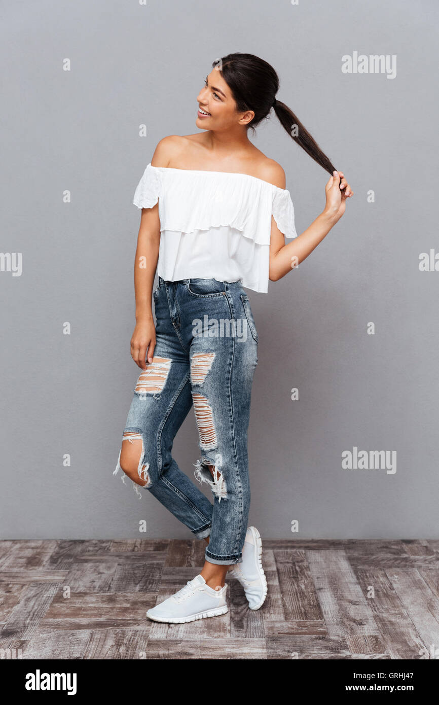 Full length portrait of a casual beautiful woman posing isolated on a ...