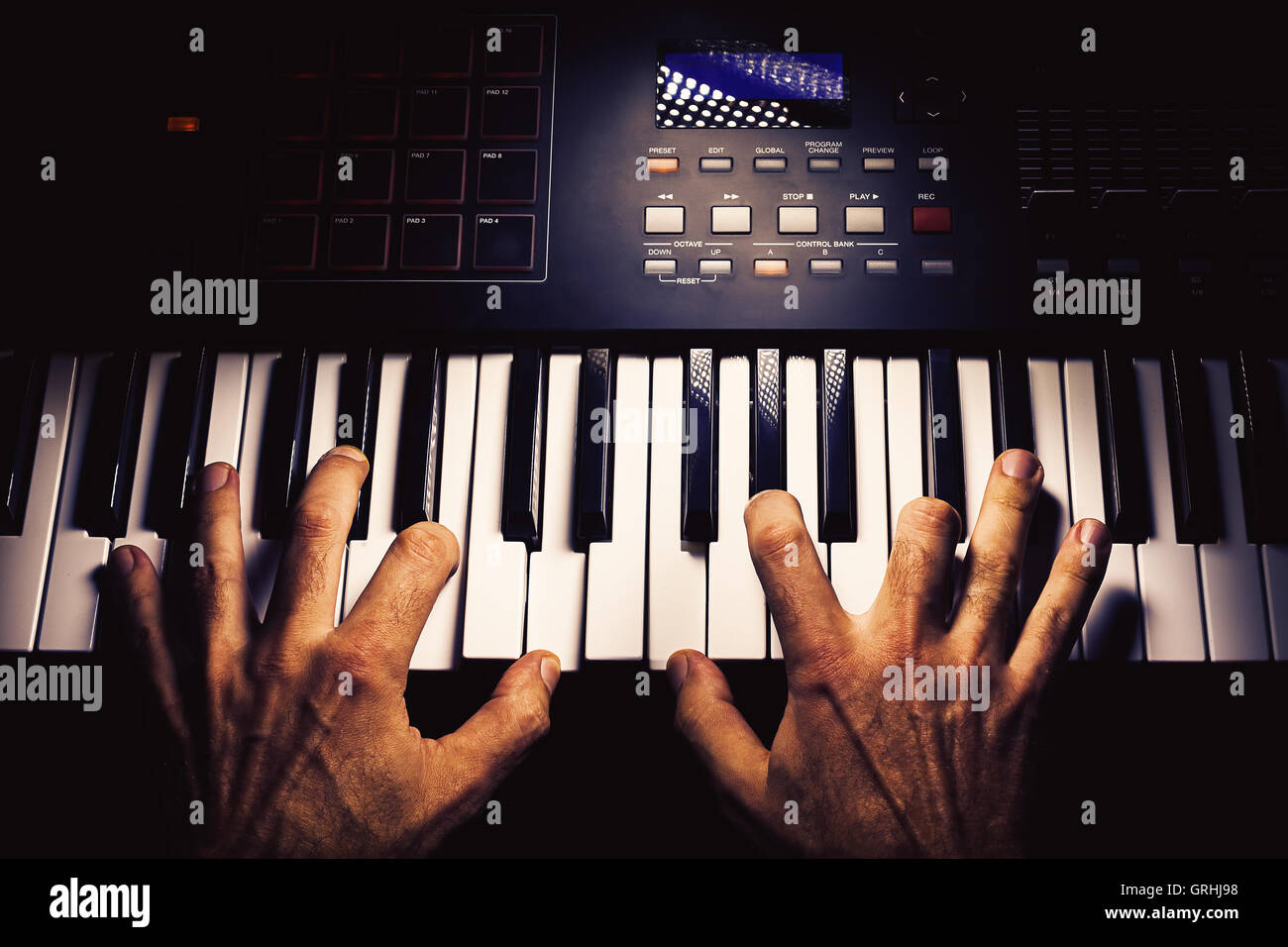 Details of a modern midi keyboard with male hands playing on it Stock ...