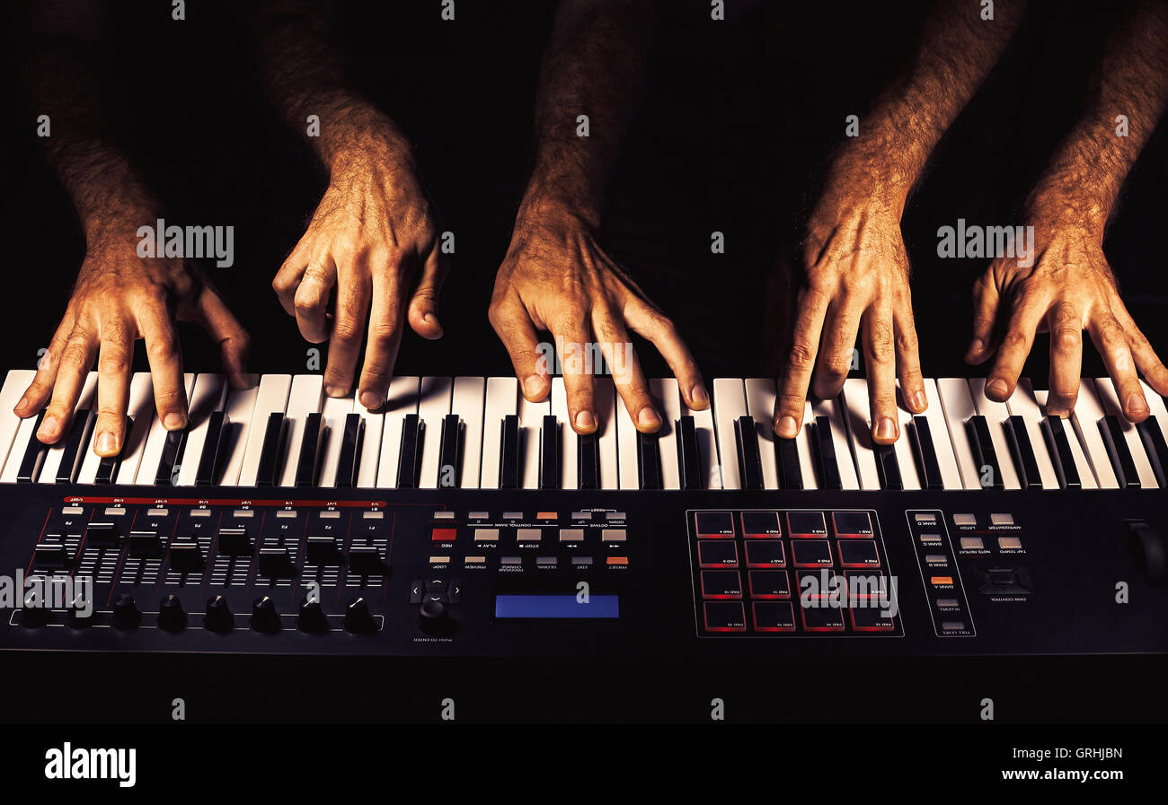Details of a modern midi keyboard with male hands playing on it Stock ...