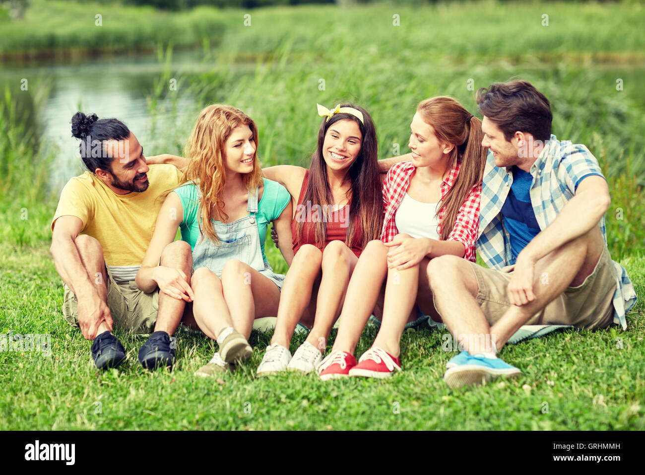 group of smiling friends talking outdoors Stock Photo - Alamy