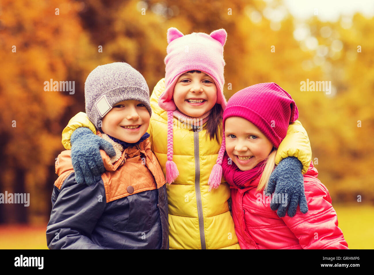 group of happy children hugging in autumn park Stock Photo - Alamy