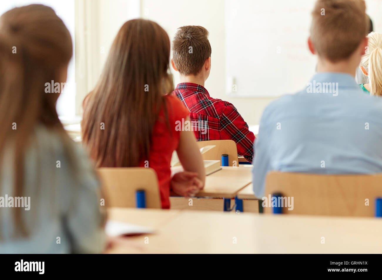 group of students with notebooks at school lesson Stock Photo - Alamy
